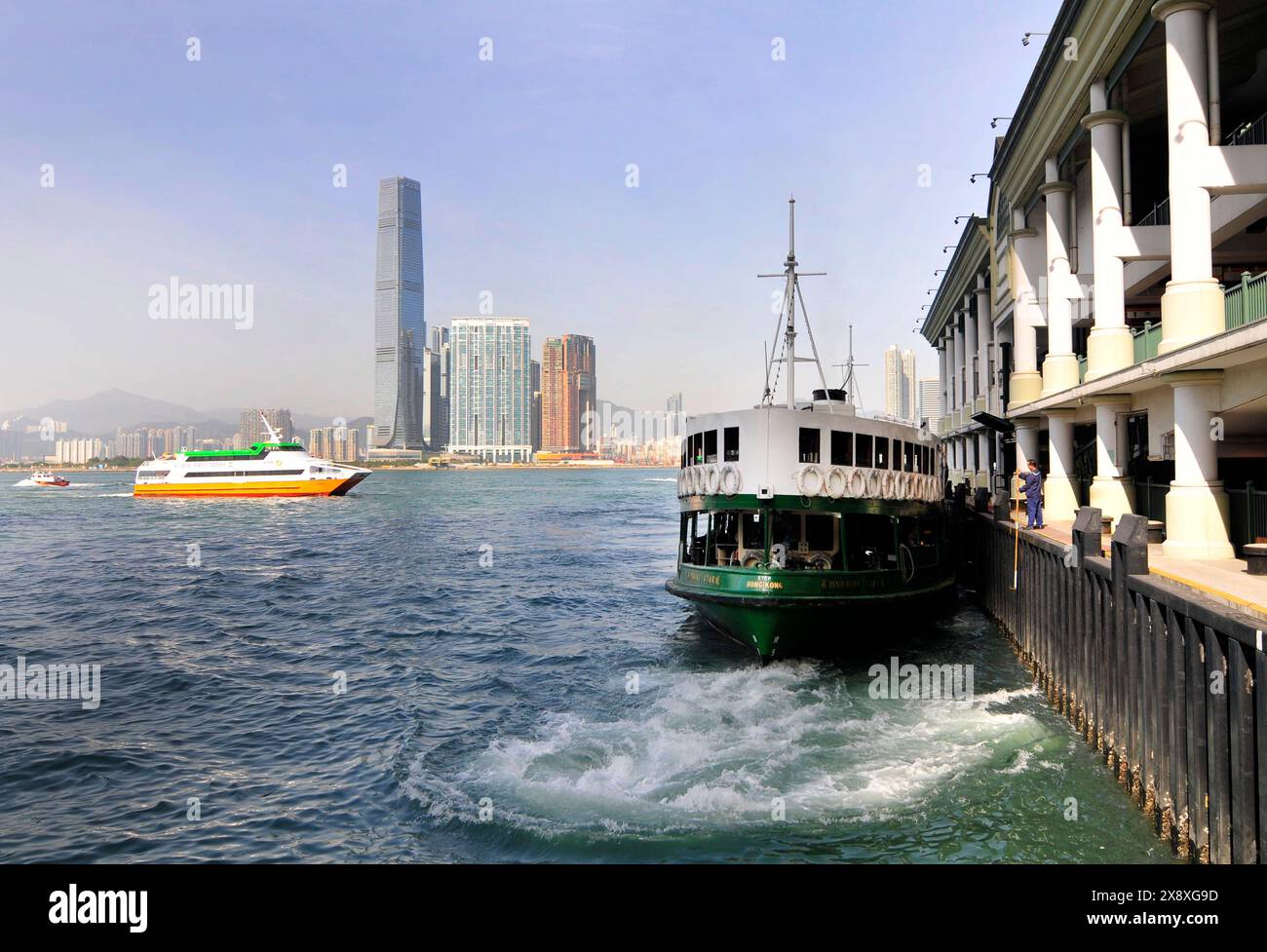 The iconic Star Ferry docking at the pier in the Cental piers with a ...