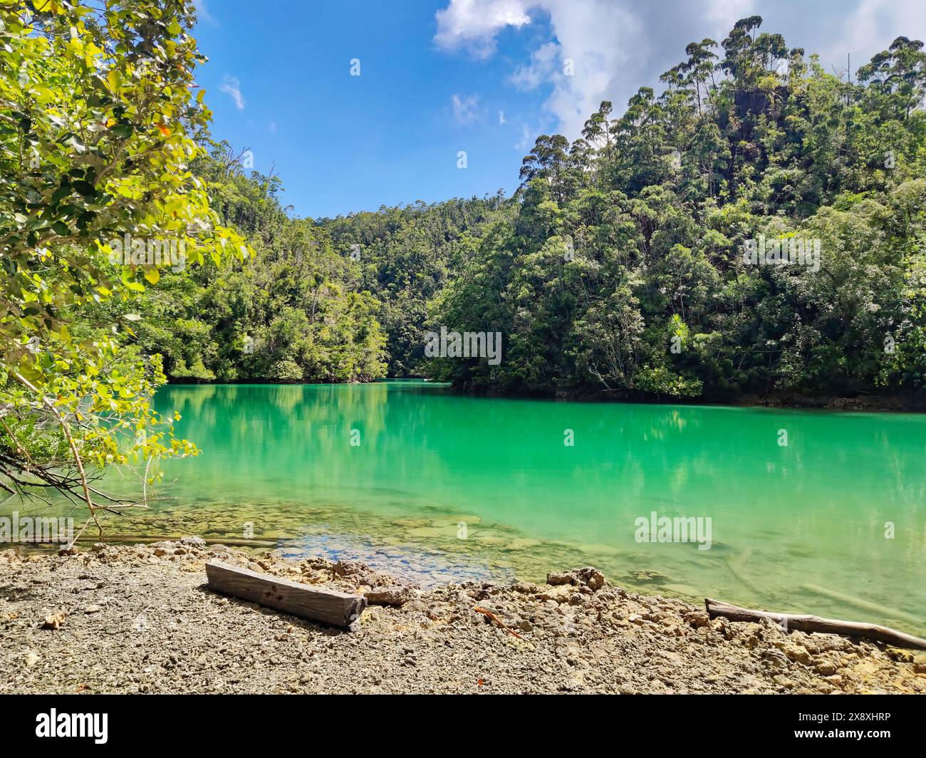 A picturesque scene of hills towering over a serene, azure lagoon Stock ...