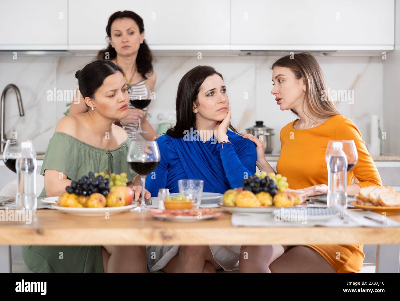 Group of female friends calming woman Stock Photo - Alamy