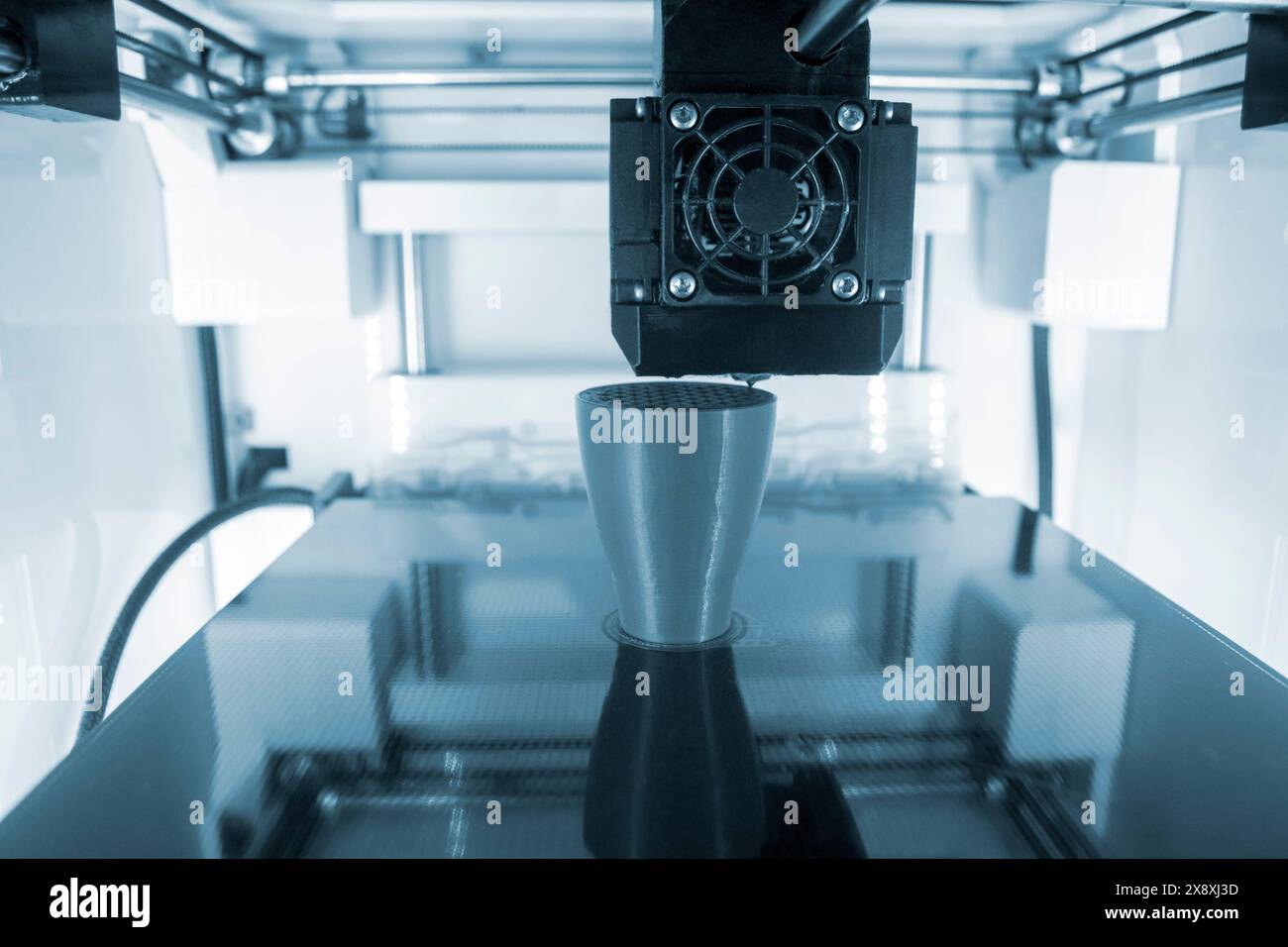 3D printer working close-up. 3D printer prints model from molten ...