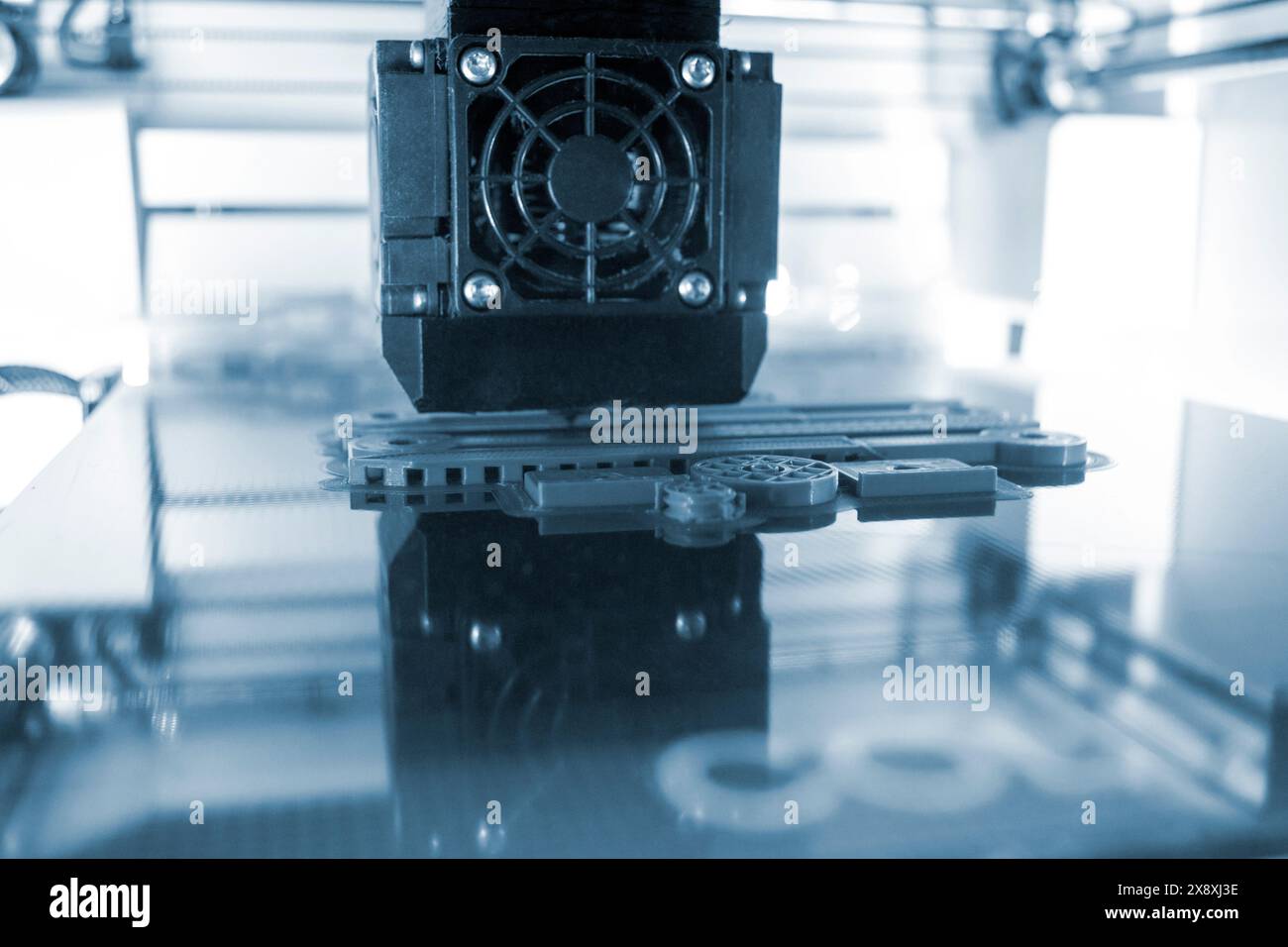 3D printer working close-up. 3D printer prints model from molten ...