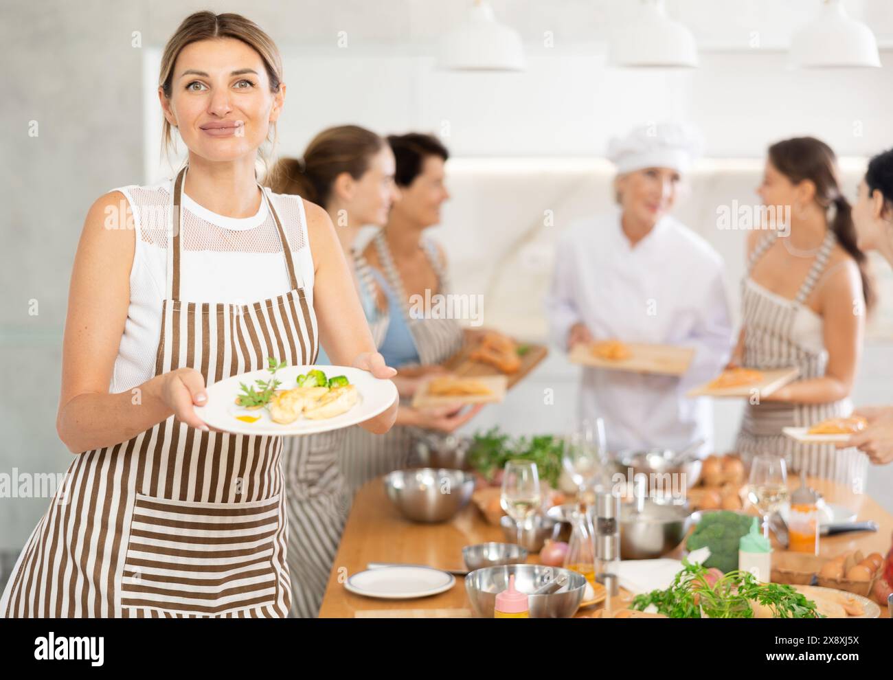 Young woman posing with cooked chicken at master class Stock Photo - Alamy