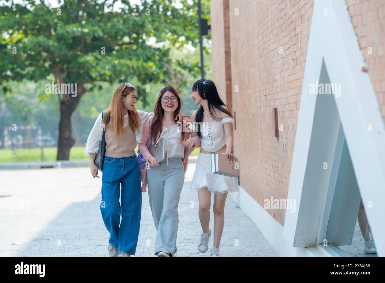 College students walking together outdoors, Group of happy friend ...