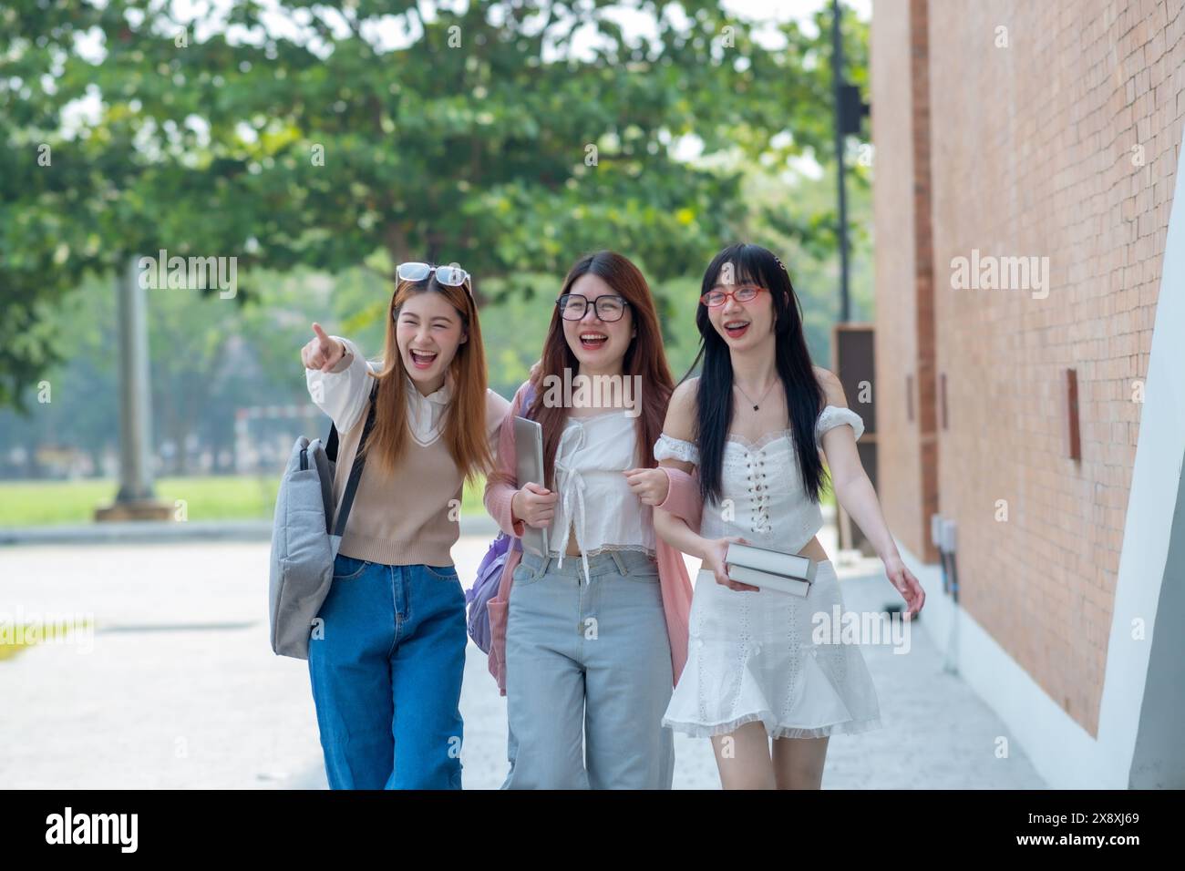 College students walking together outdoors, Group of happy friend ...