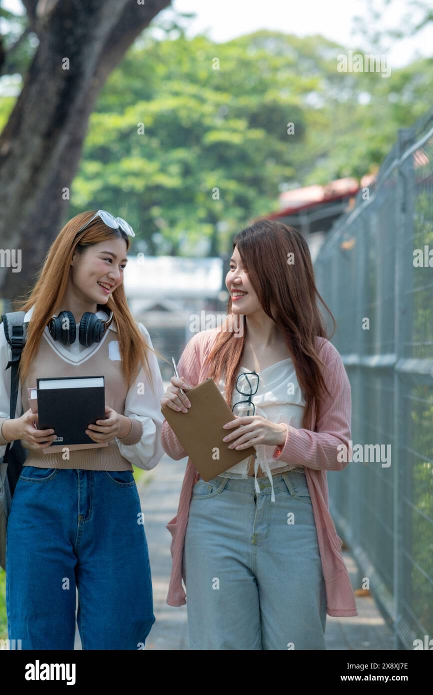 College students walking together outdoors, Group of happy friend ... College students walking together outdoors, Group of happy friend ...