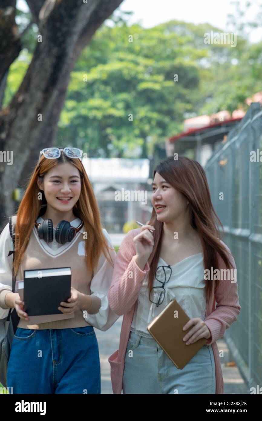 College students walking together outdoors, Group of happy friend ...