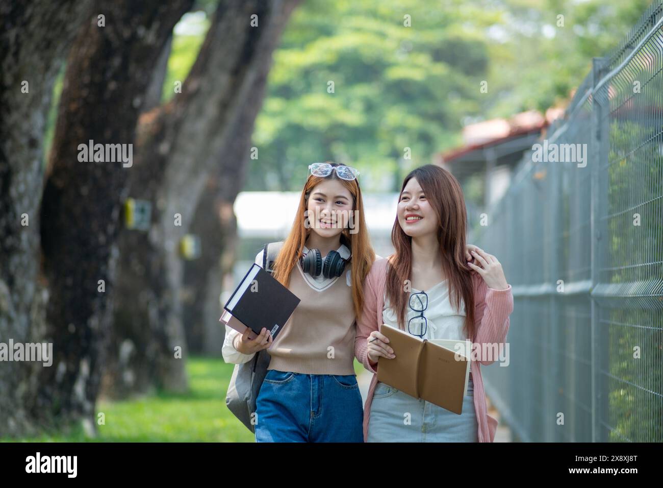 College students walking together outdoors, Group of happy friend ...