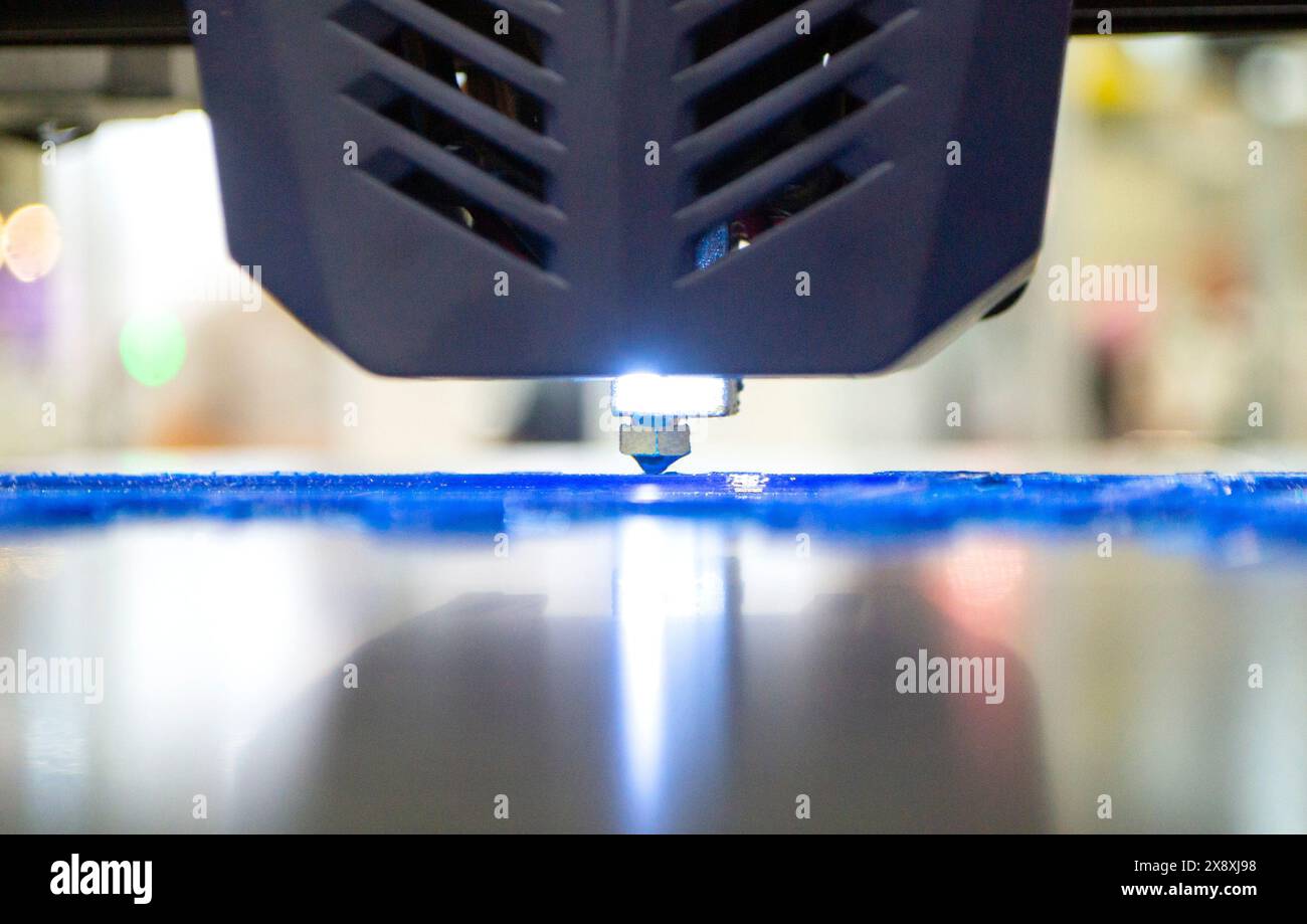 3D printer working close-up. 3D printer prints model from molten ...
