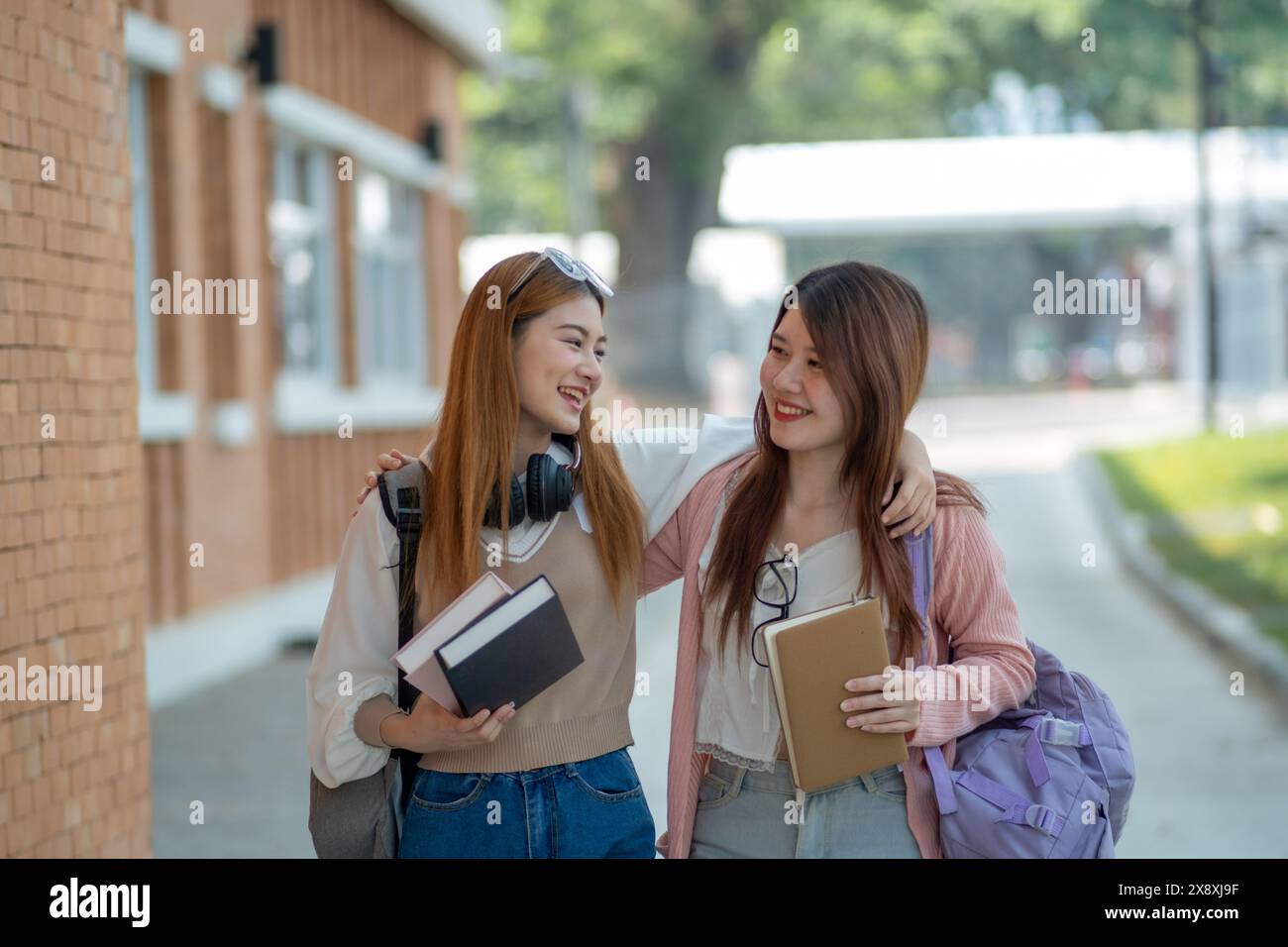College students walking together outdoors, Group of happy friend ...