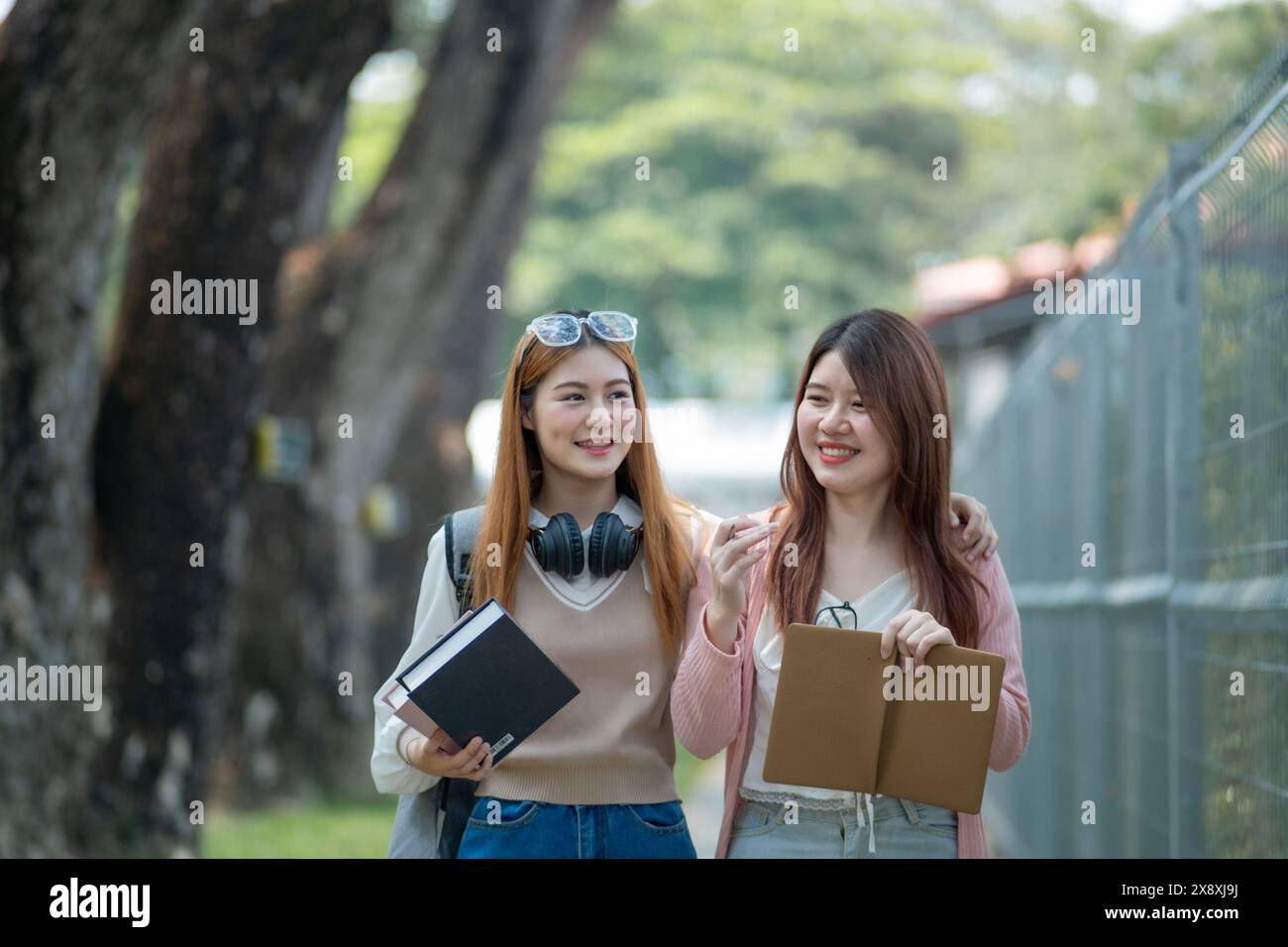 College students walking together outdoors, Group of happy friend ...