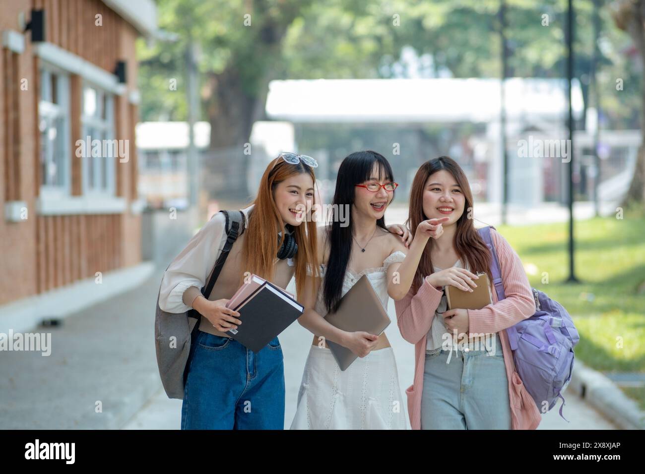College students walking together outdoors, Group of happy friend ...