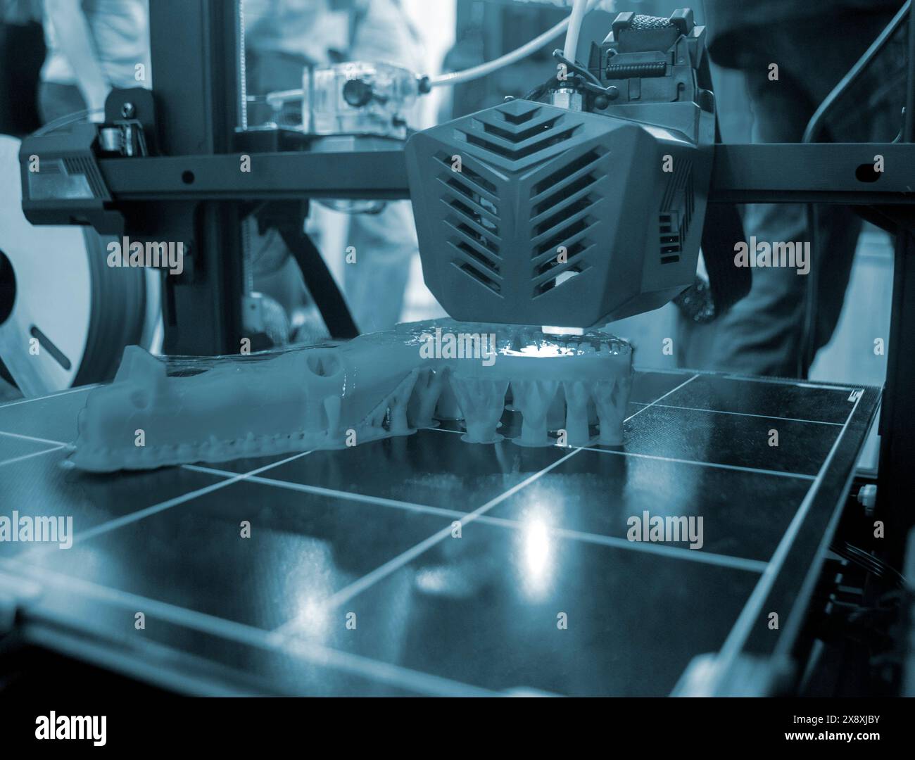 3D printer working close-up. 3D printer prints model from molten ...