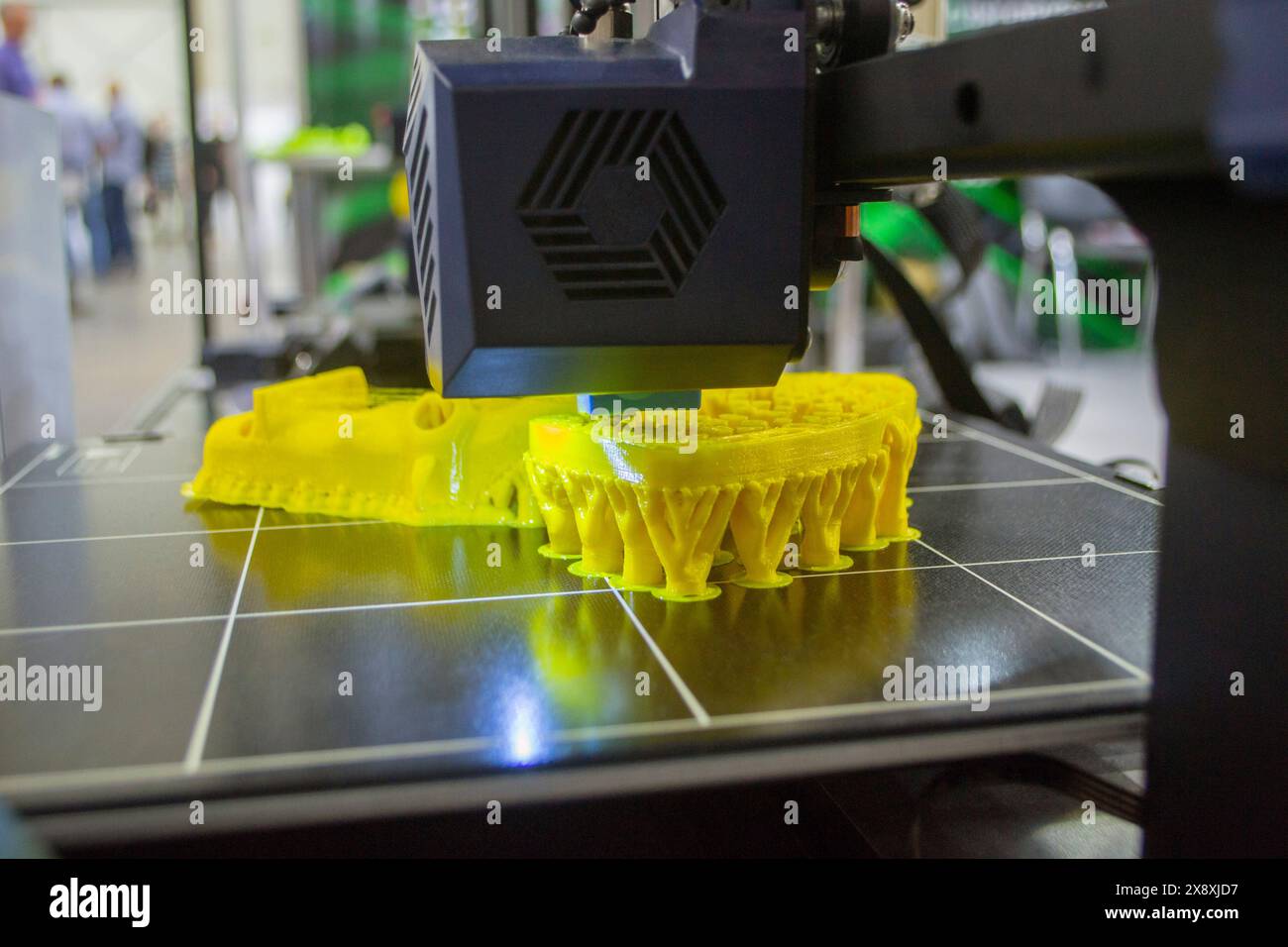 3D printer working close-up. 3D printer prints model from molten ...