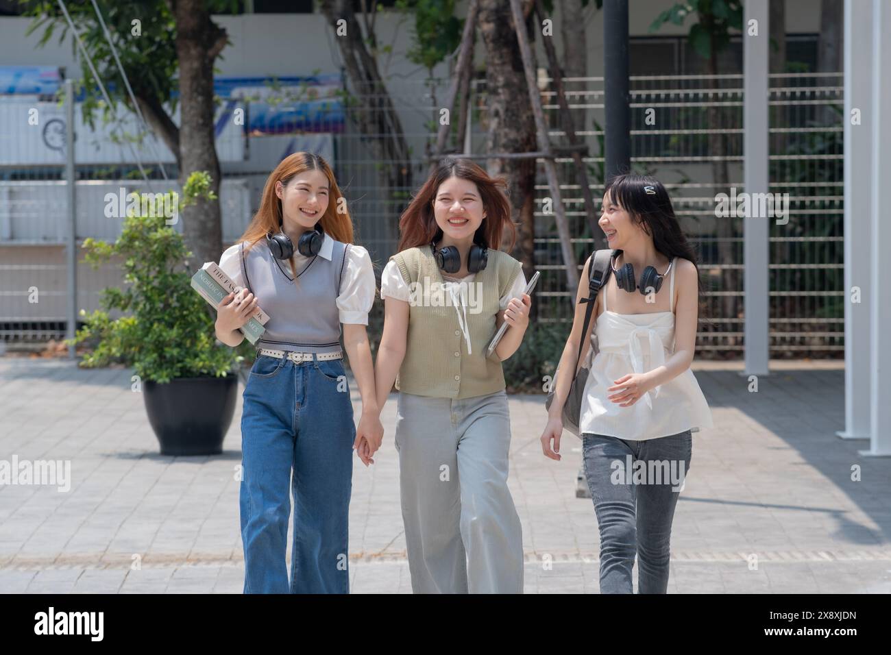 College students walking together outdoors, Group of happy friend ...
