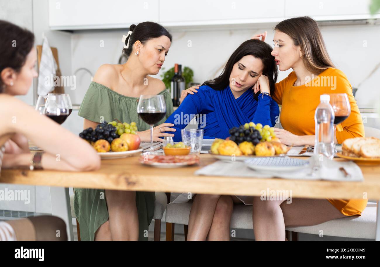 Group of female friends calming woman Stock Photo - Alamy