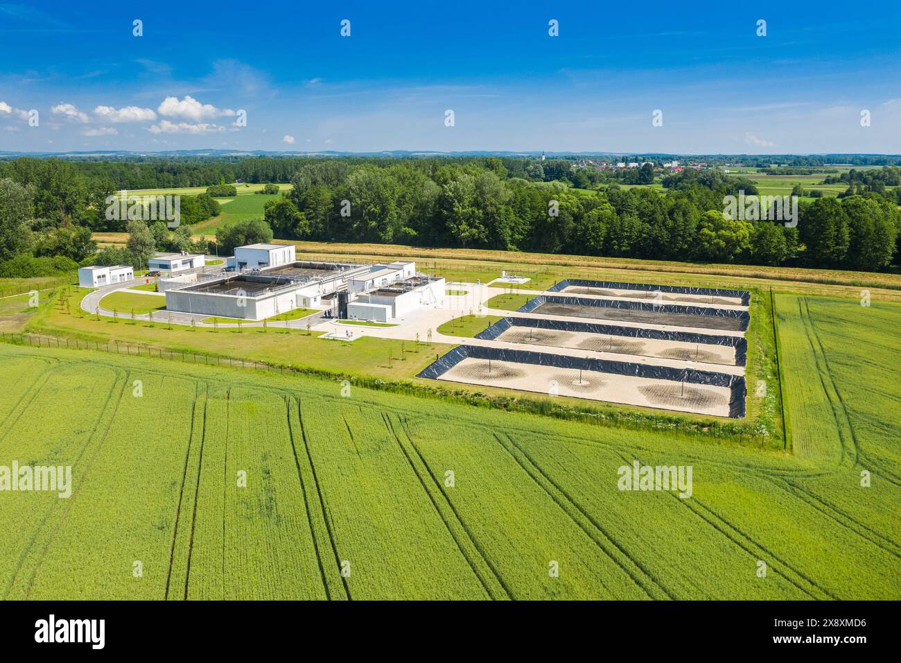 Aerial view of modern sewage treatment plant and agricultural fields in ...