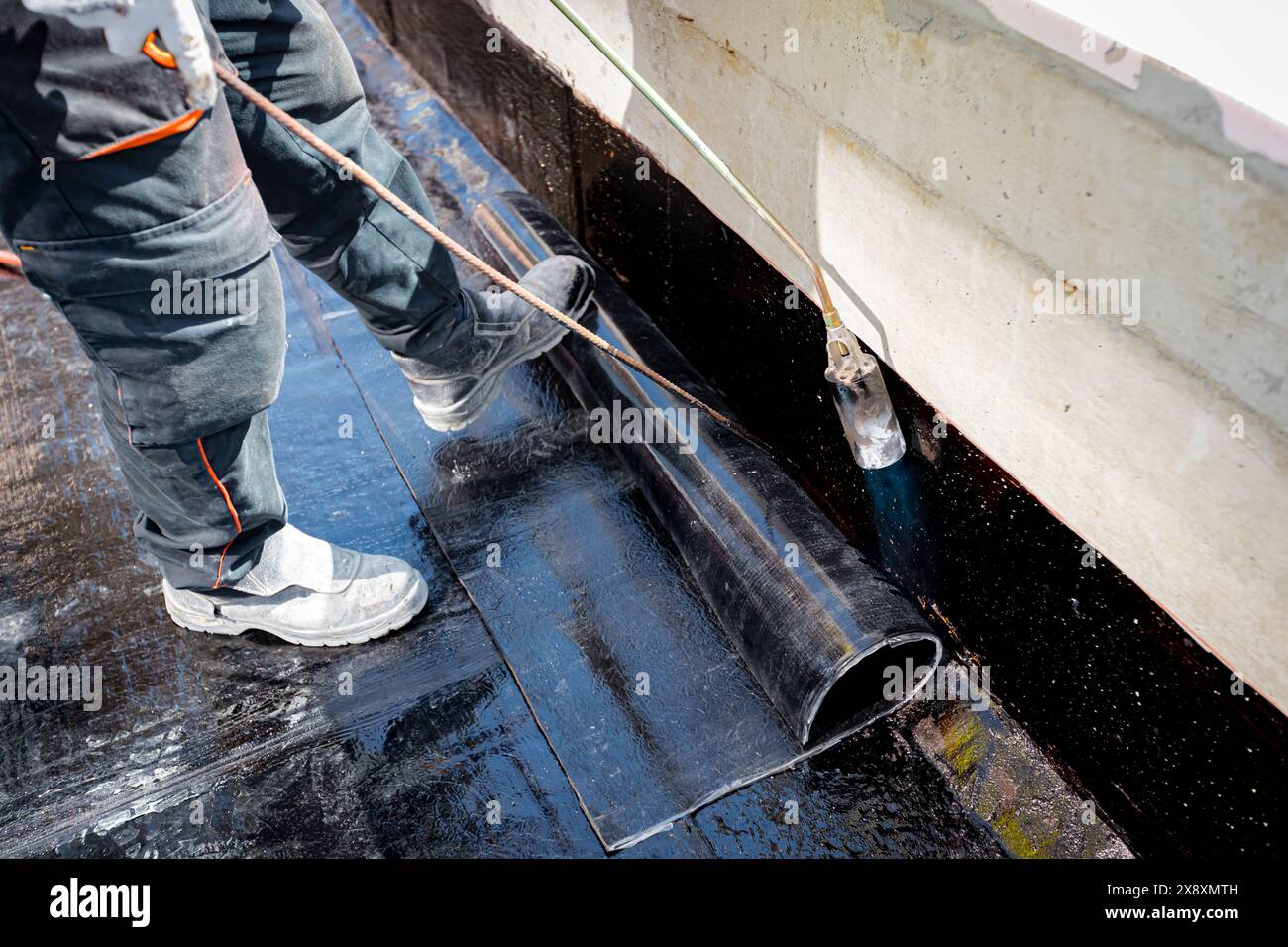 Worker is unroll rolled up, sheet of waterproofing installation ...