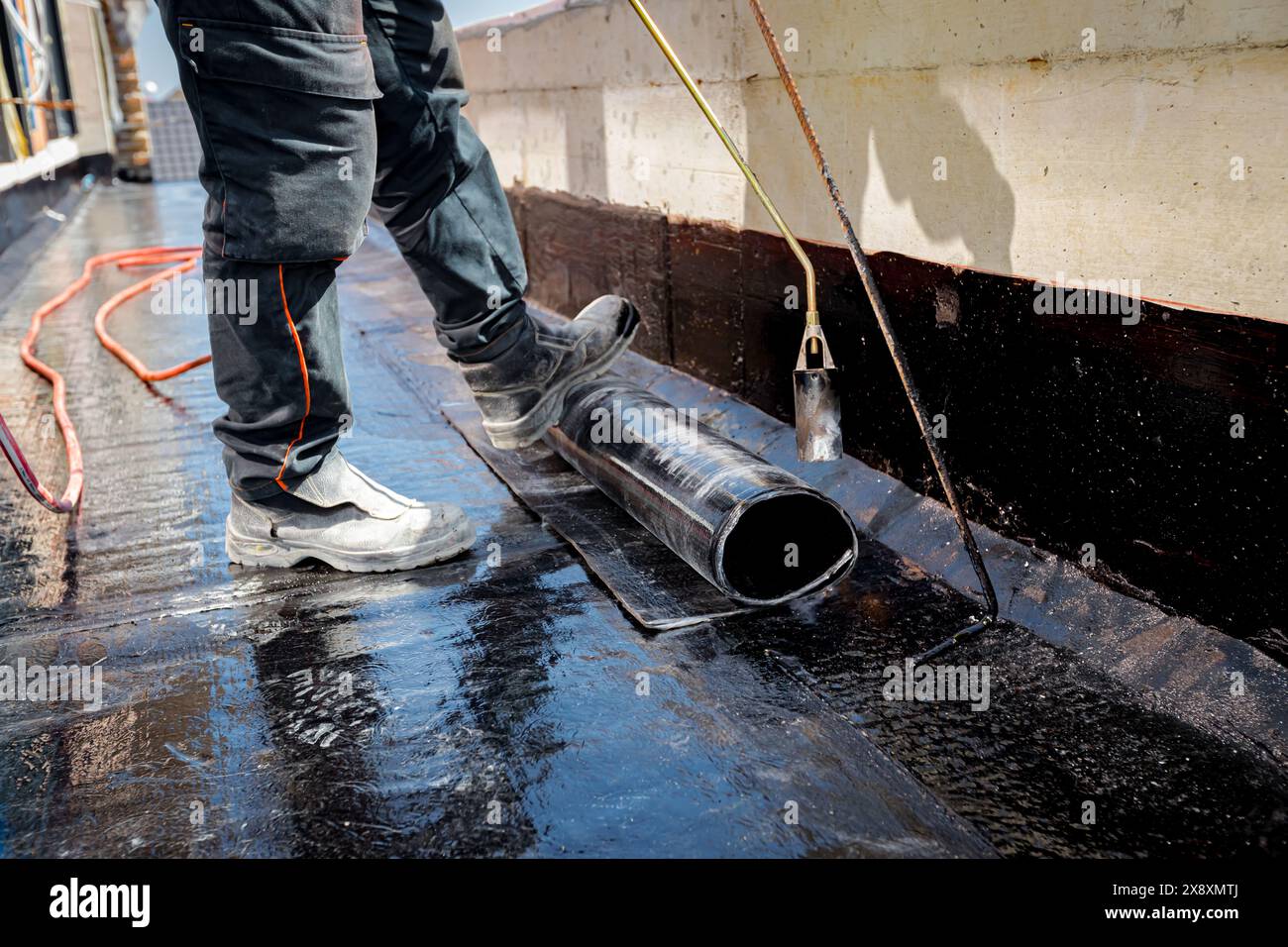 Worker is unroll rolled up, sheet of waterproofing installation ...