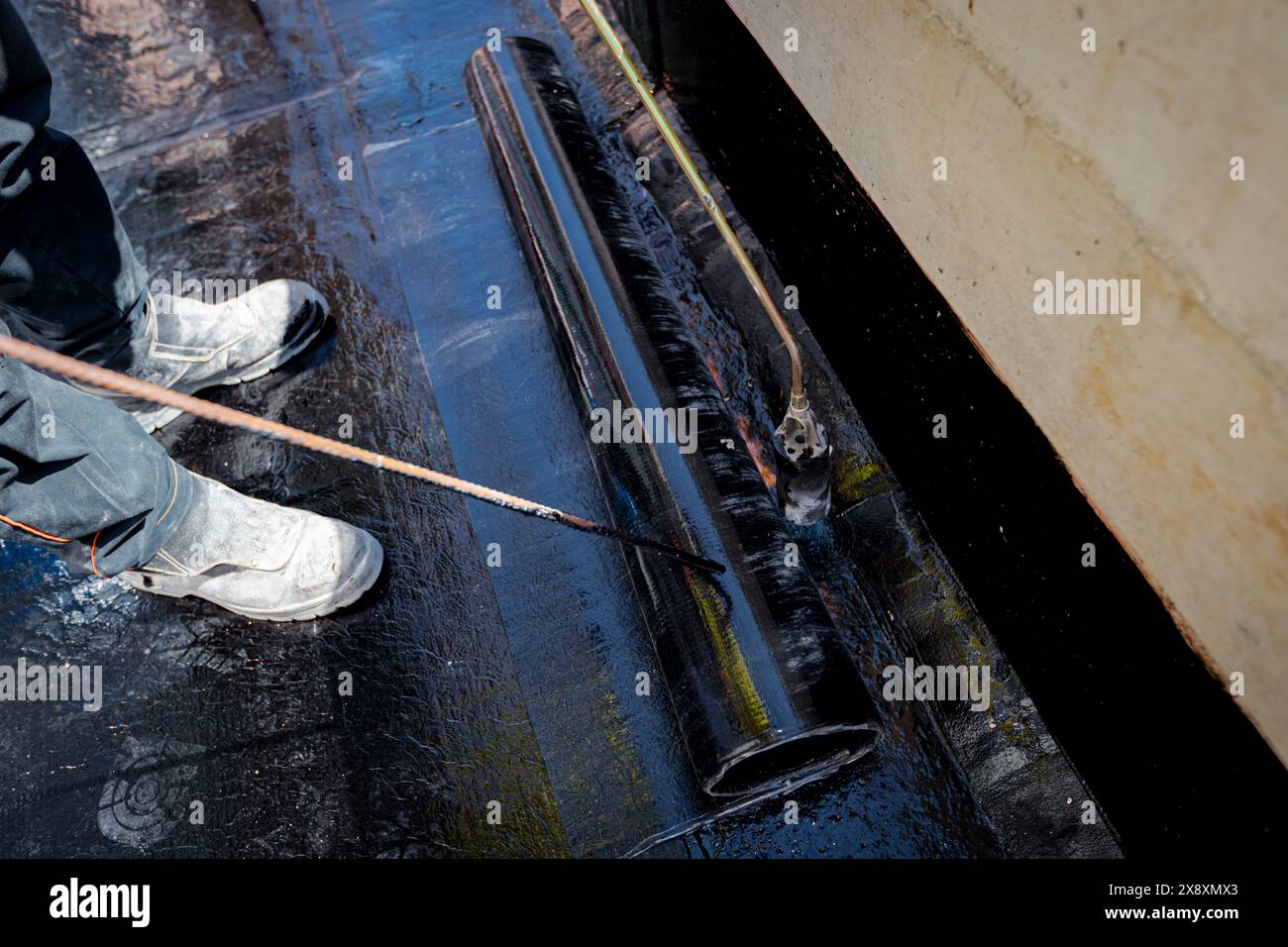 Worker is unroll rolled up, sheet of waterproofing installation ...