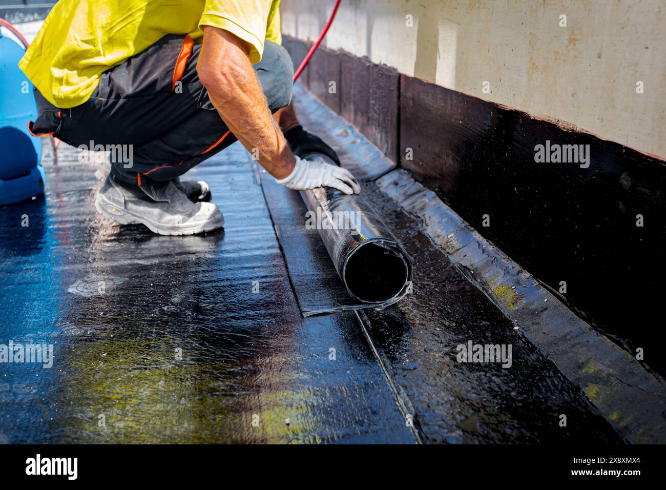 Worker in gloves prepare for melting, manually place and unroll rolled ...