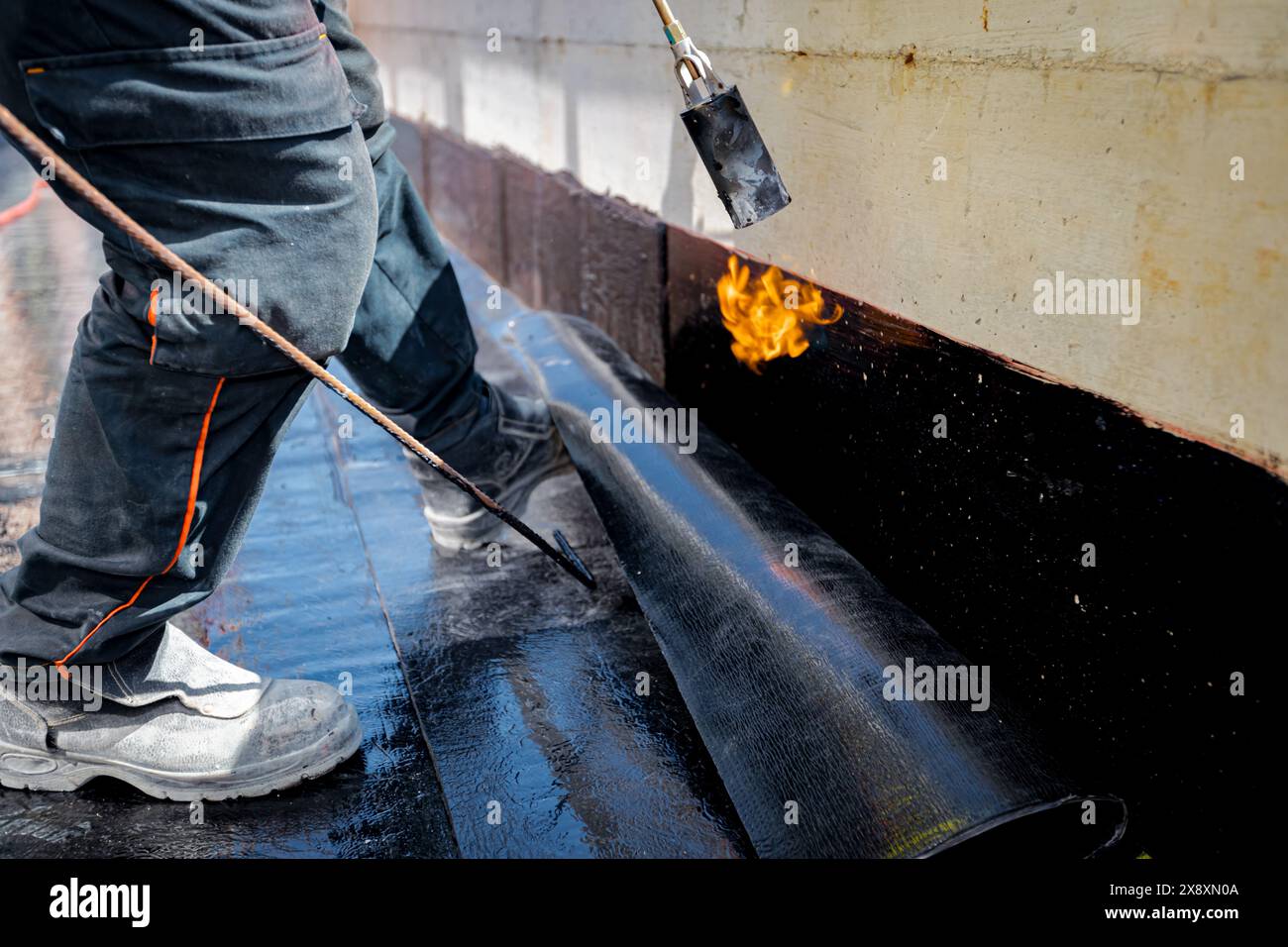 Worker is unroll rolled up, sheet of waterproofing installation ...