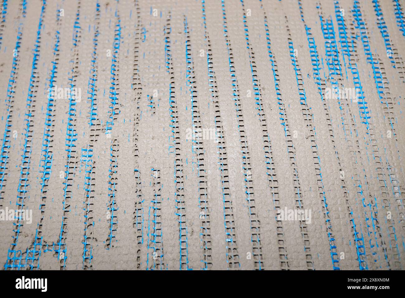 First, layer of construction glue on insulated wall for covering ...