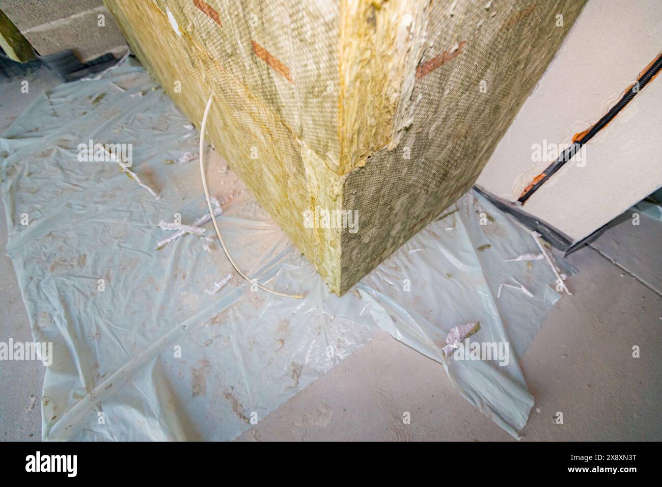 Corner of indoor wall with unfinished thermal insulation, layer of rock ...