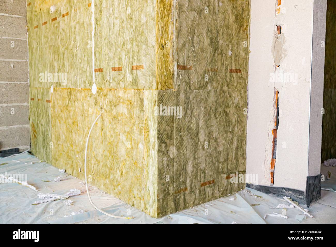 Corner of indoor wall with unfinished thermal insulation, layer of rock ...