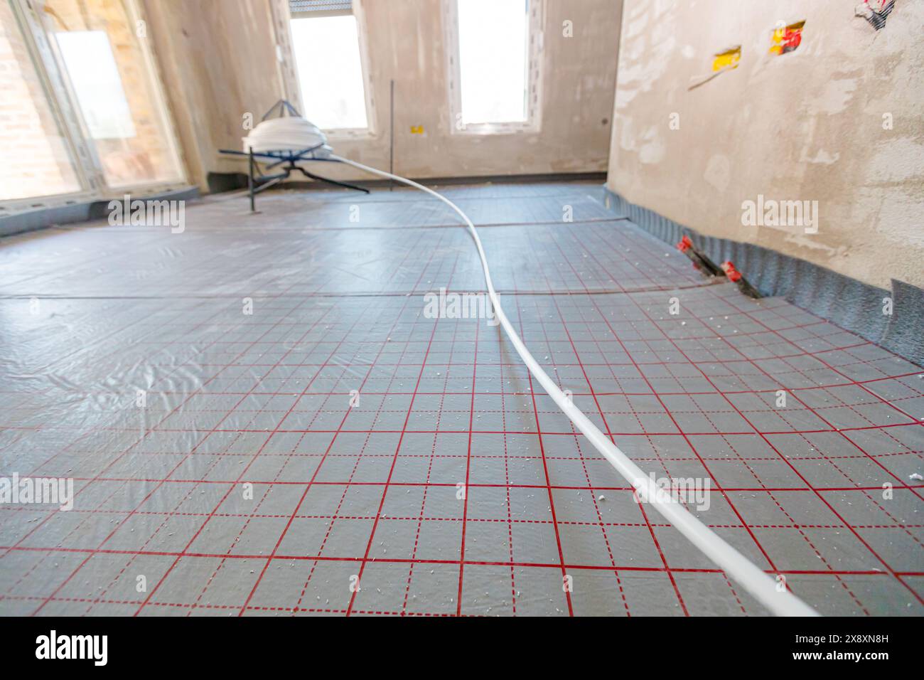 Long thin white tube unrolled over divided surface, with red auxiliary ...