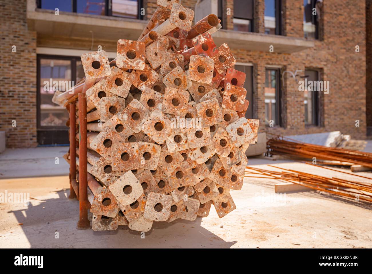 Stack of metal rusty pipes in improvised pallet, carrier, for transport ...