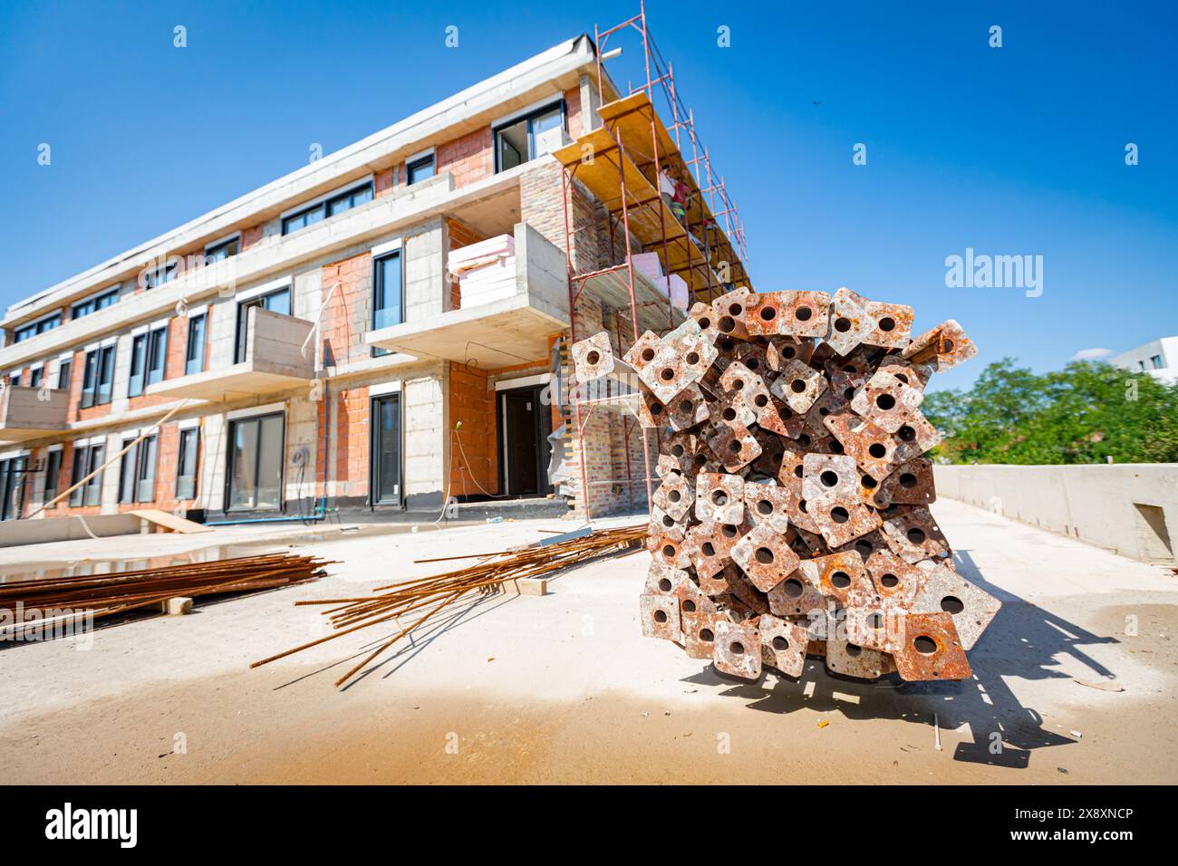 Stack of metal rusty pipes in improvised pallet, carrier, for transport ...