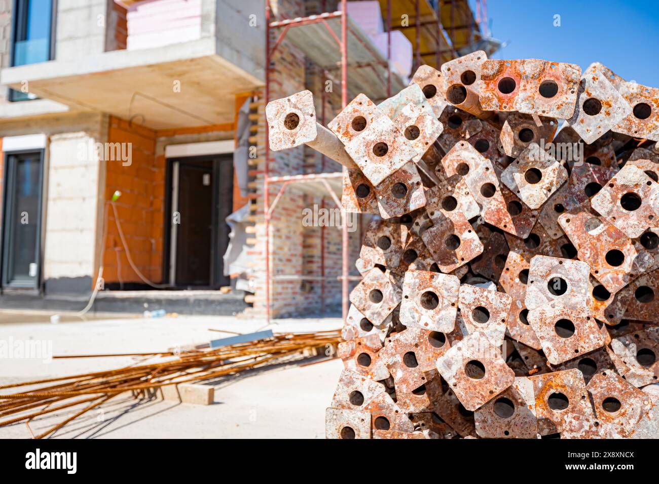 Stack of metal rusty pipes in improvised pallet, carrier, for transport ...