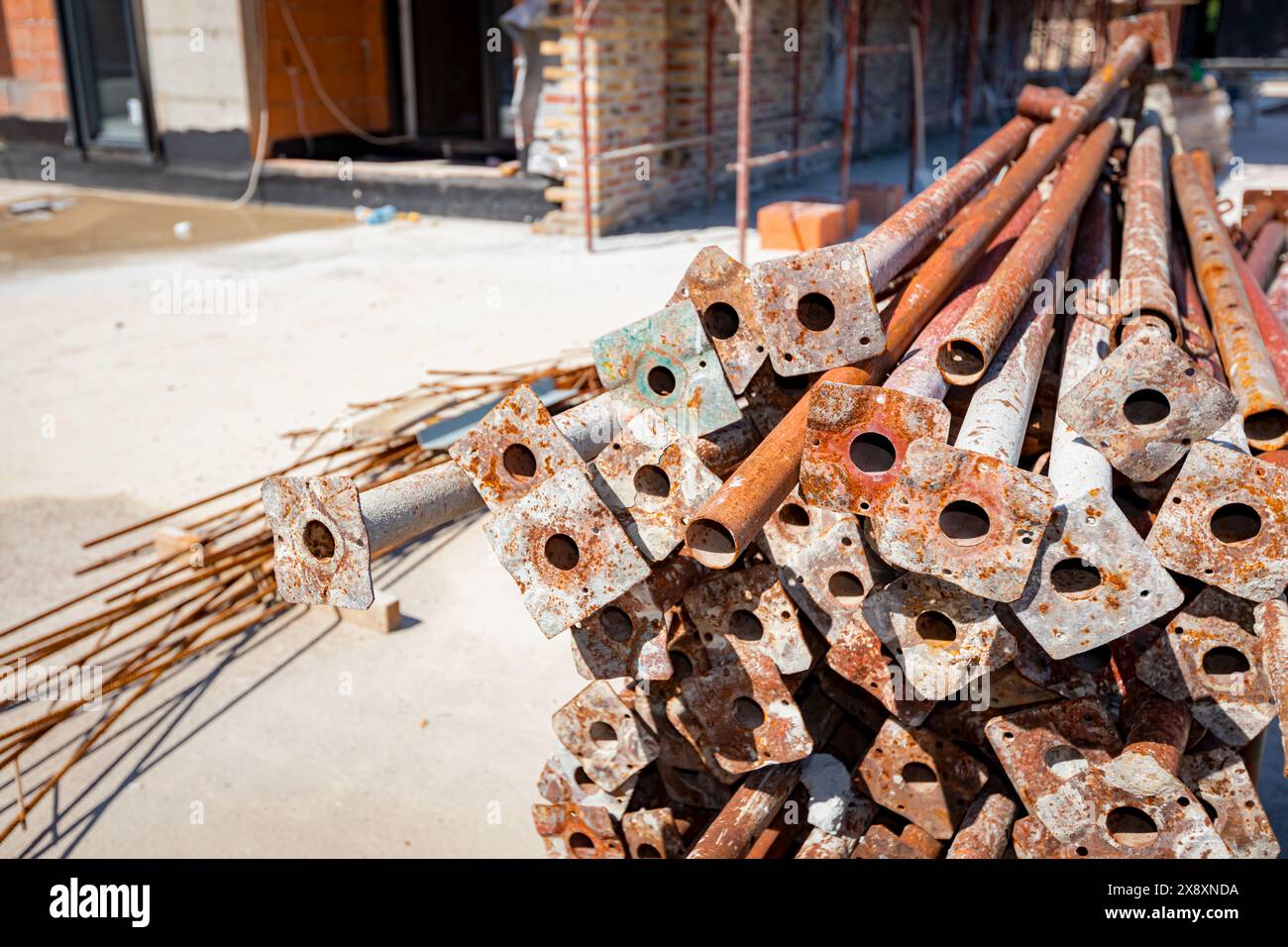 Stack of metal rusty pipes in improvised pallet, carrier, for transport ...