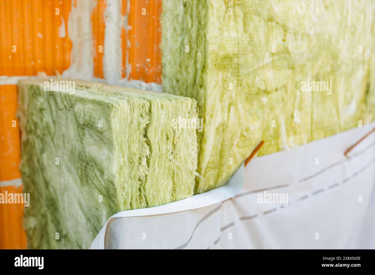 New facade is under construction, outdoor brick wall, between is fiber ...