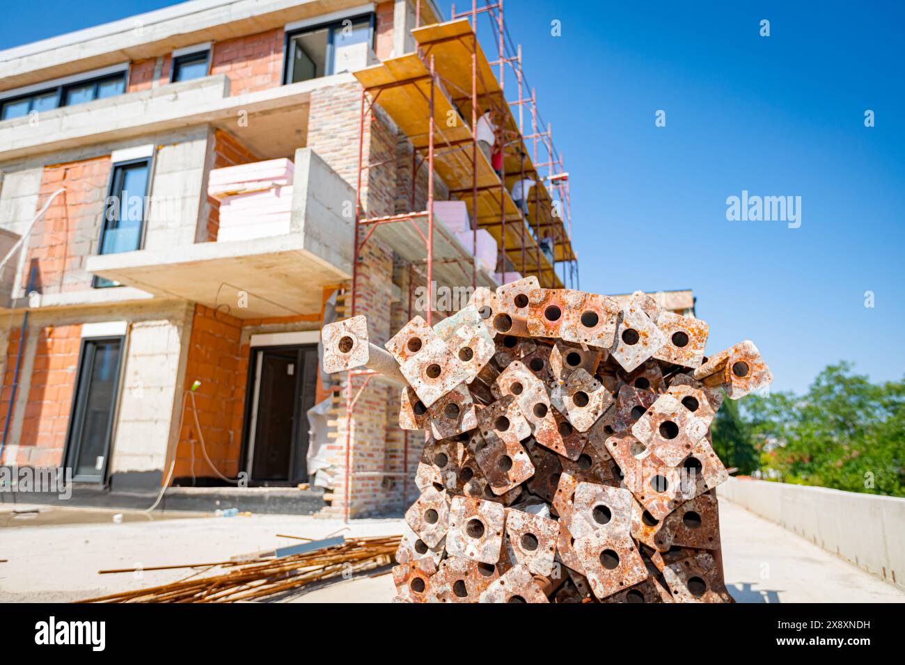 Stack of metal rusty pipes in improvised pallet, carrier, for transport ...