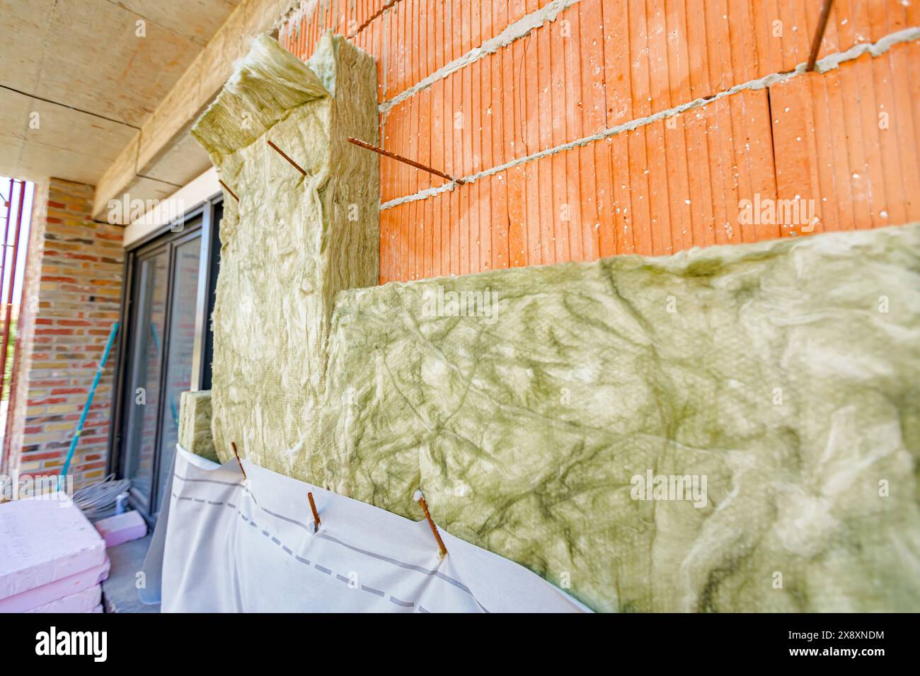 New facade is under construction, outdoor brick wall, between is fiber ...