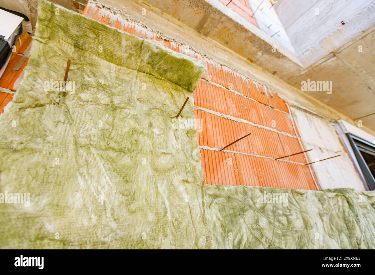 New facade is under construction, outdoor brick wall, between is fiber ...