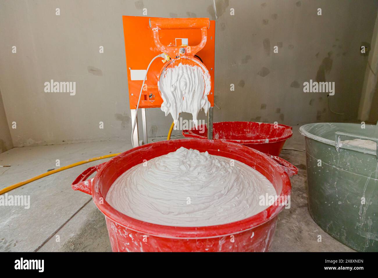 Electric mixer for mixes dry white putty, stir plaster and water in a ...