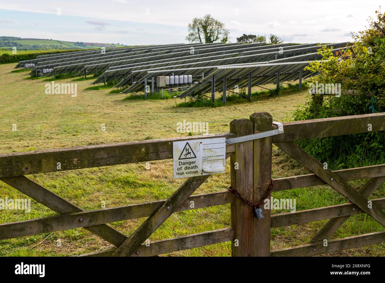 danger of death sign on gate to field of solar panels, Dartington Hall ...