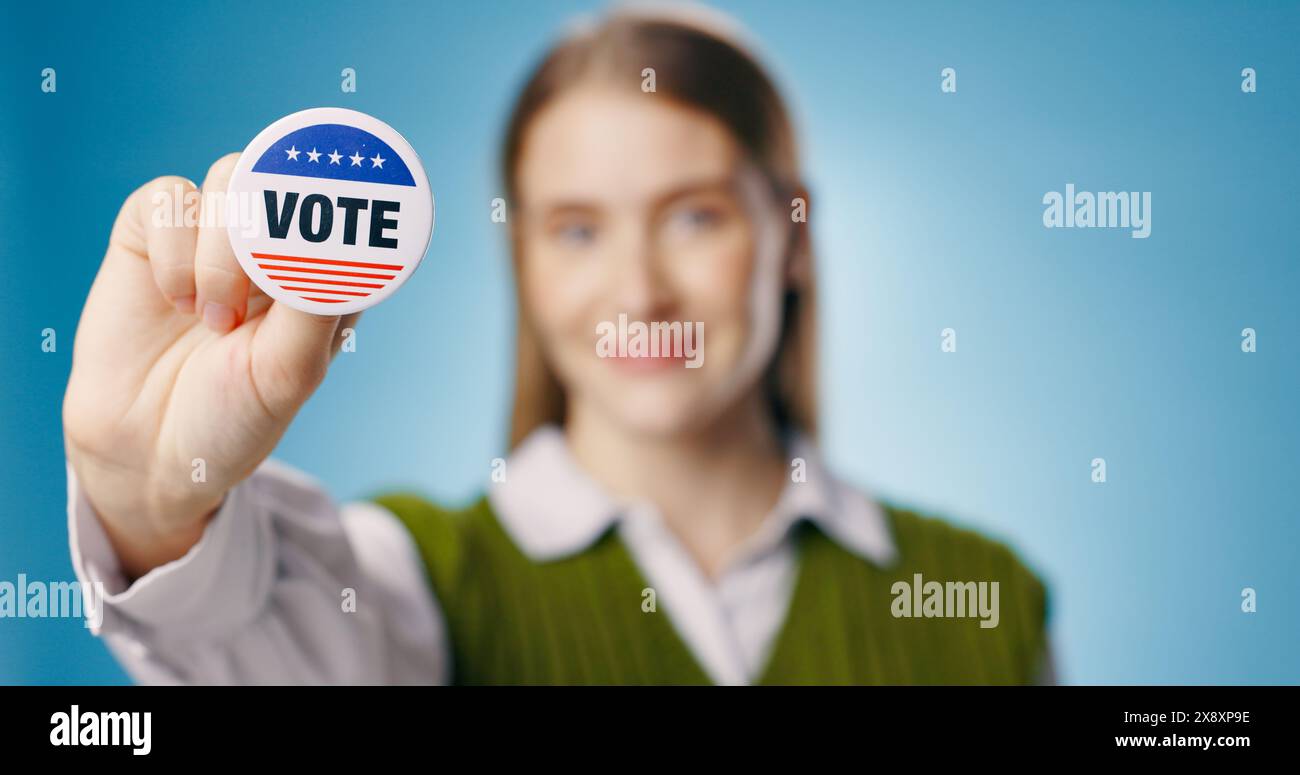 Vote, badge and hand of woman for elections, political and studio with ...