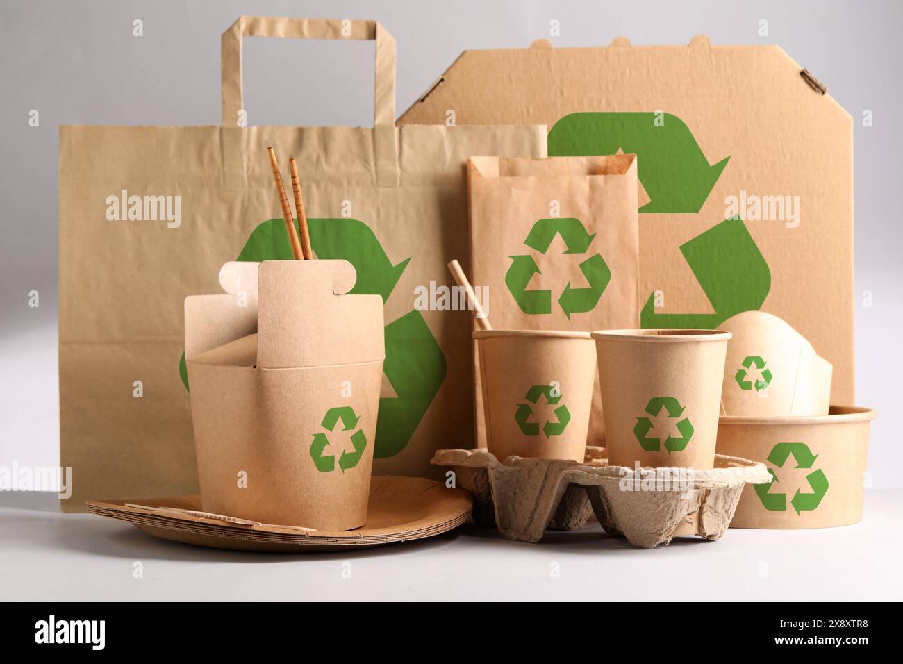 Set of eco friendly food packaging with recycling symbols on light ...