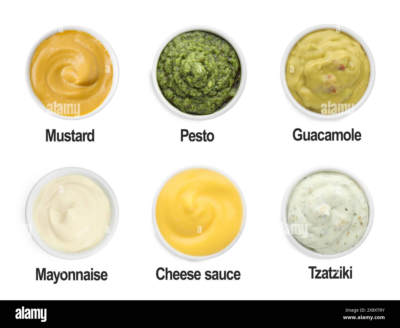 Set of different sauces in bowls and names isolated on white, top view ...
