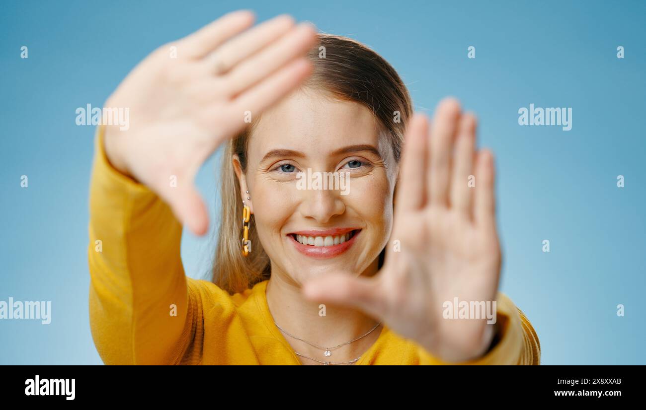 Woman, hands and frame with happy portrait or smile, photographer ...