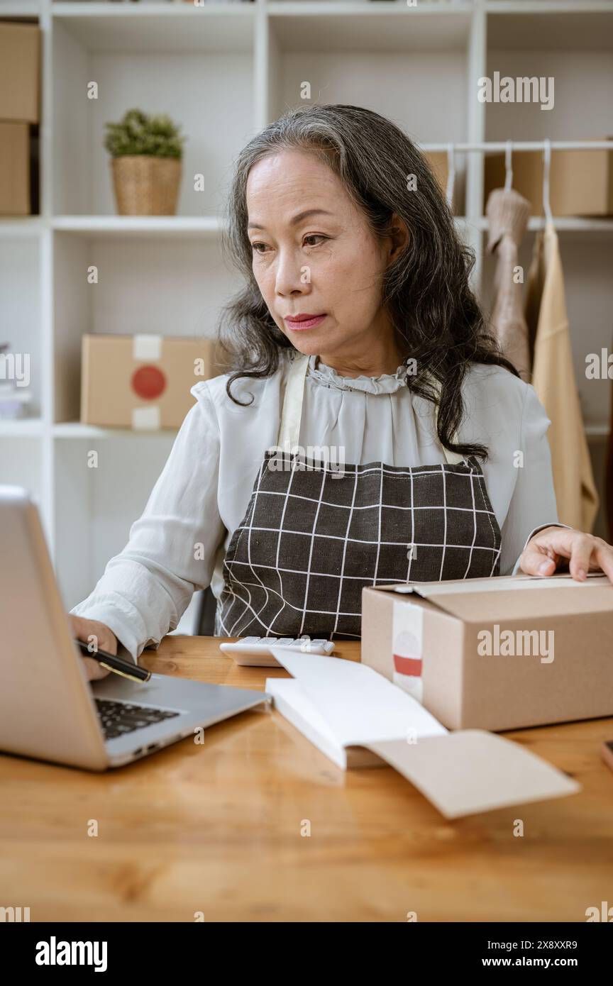 A professional, focused, mature Asian female clothes online seller or ...