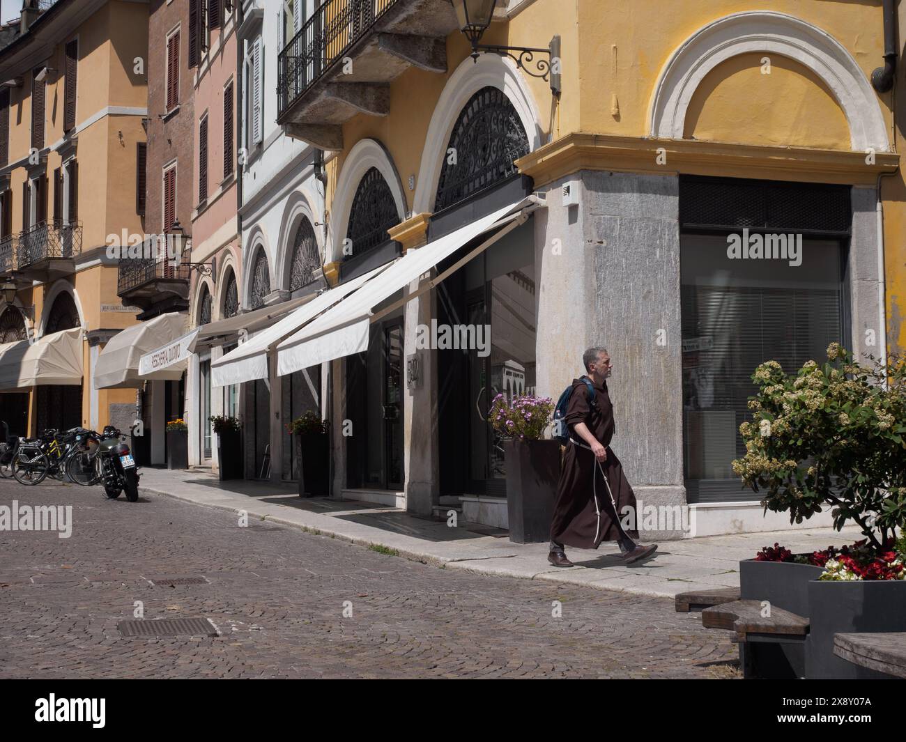 Cremona, Italy - May 15th 2024 Solitary monk in traditional robes walks ...