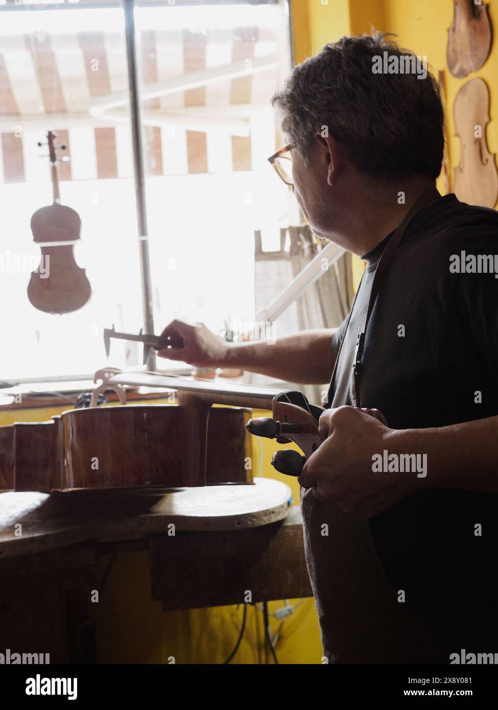 Professional violin maker crafts a handcrafted instrument in a ...