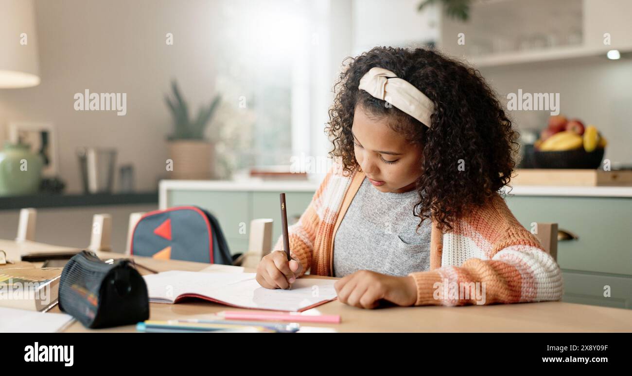Book, homework and child writing in kitchen with studying for english ...