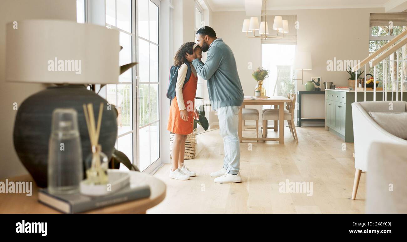 Father, child and kiss in home for school goodbye or morning routine ...