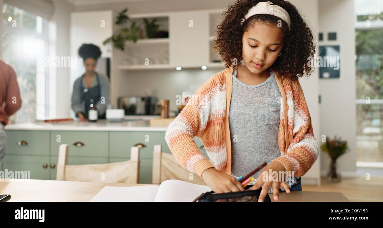 Mother cooking children studying in hi-res stock photography and images ...