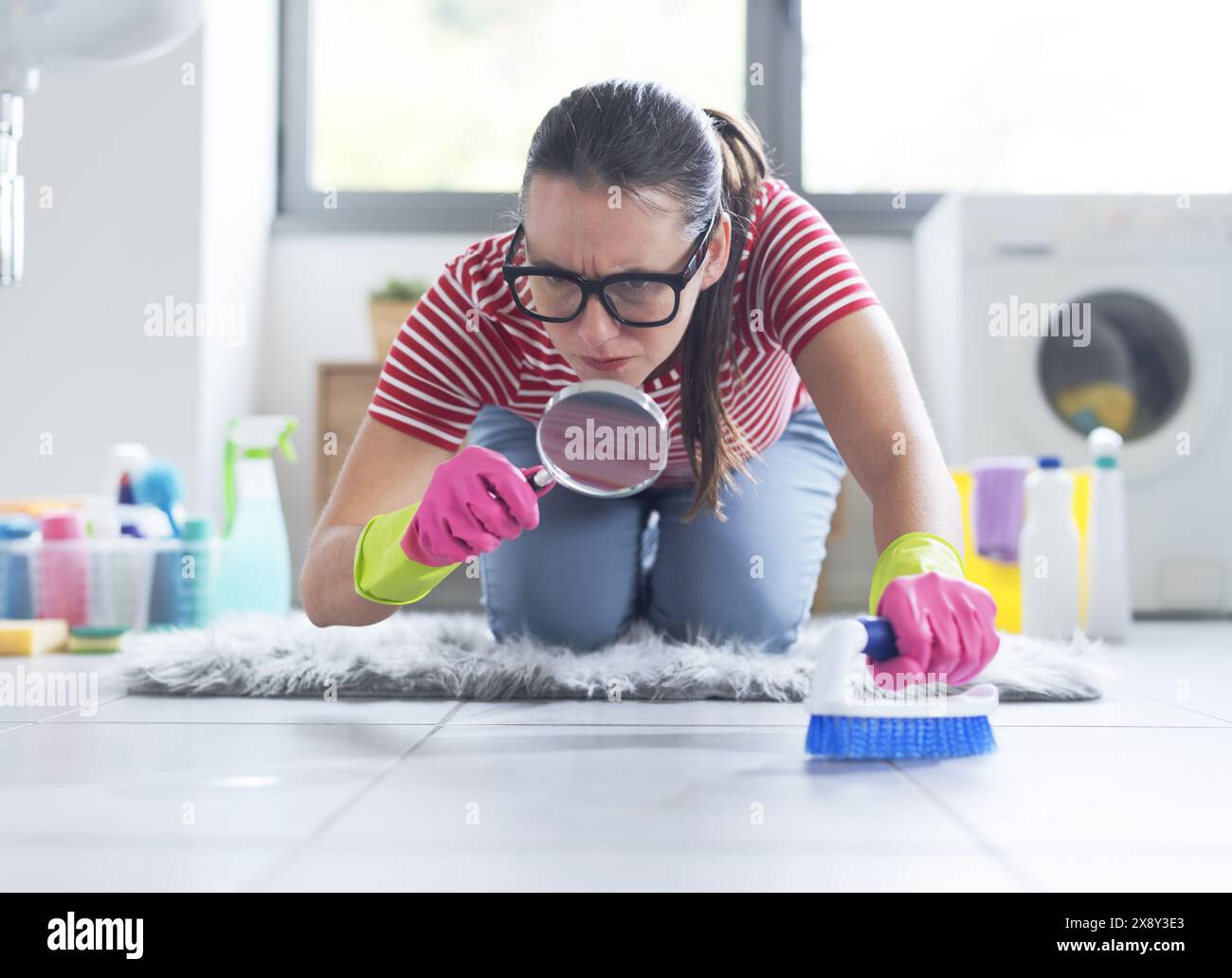 Woman obsessed with hygiene, she is checking the bathroom floor with a ...